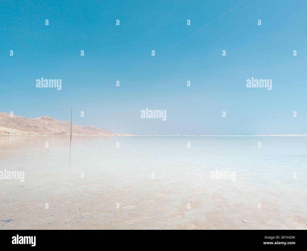 Landscape view on Dead Sea salt crystals formations, clear cyan green water at Ein Bokek beach ...