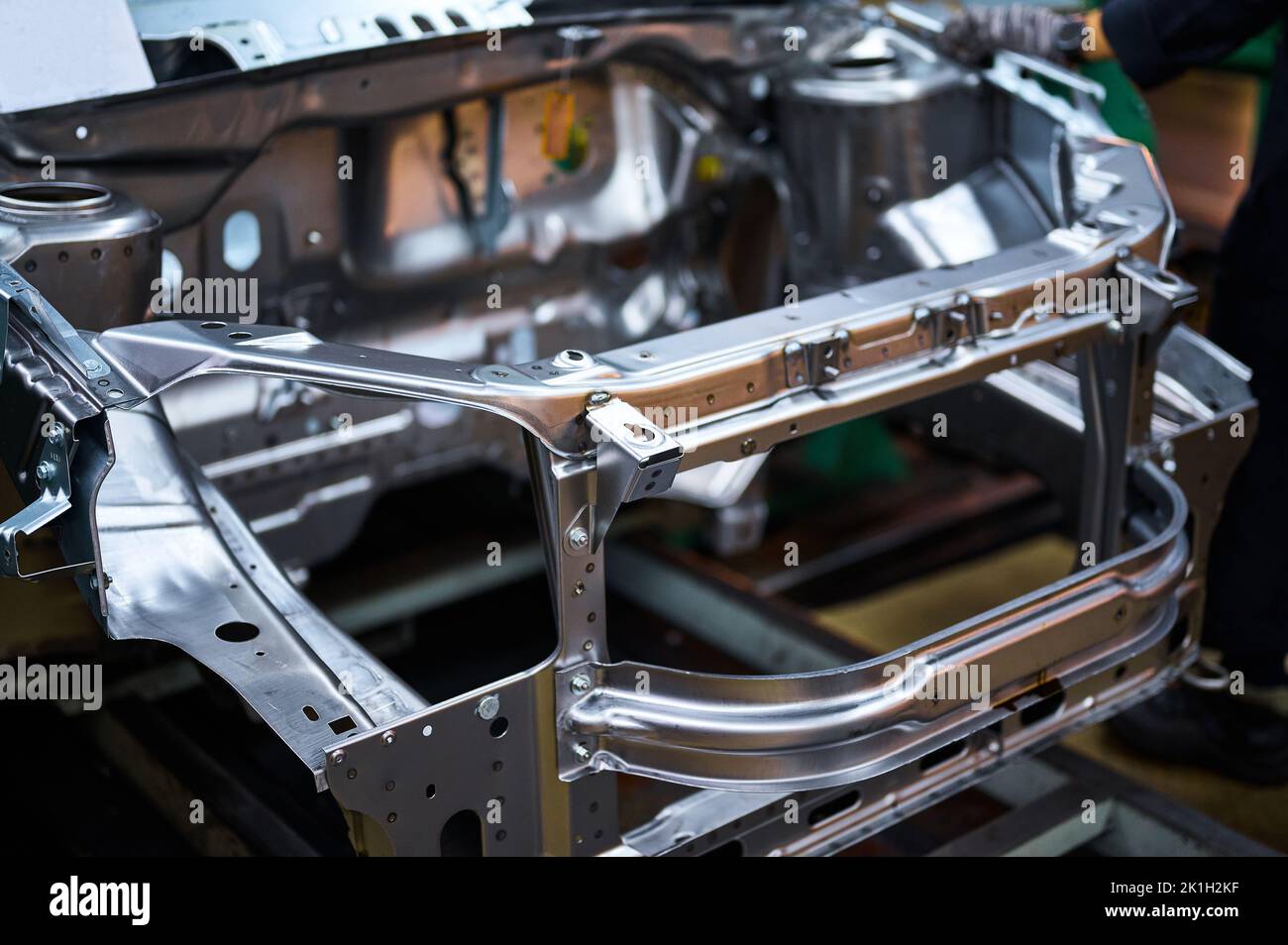 Shiny metal car body element in assembling workshop Stock Photo - Alamy