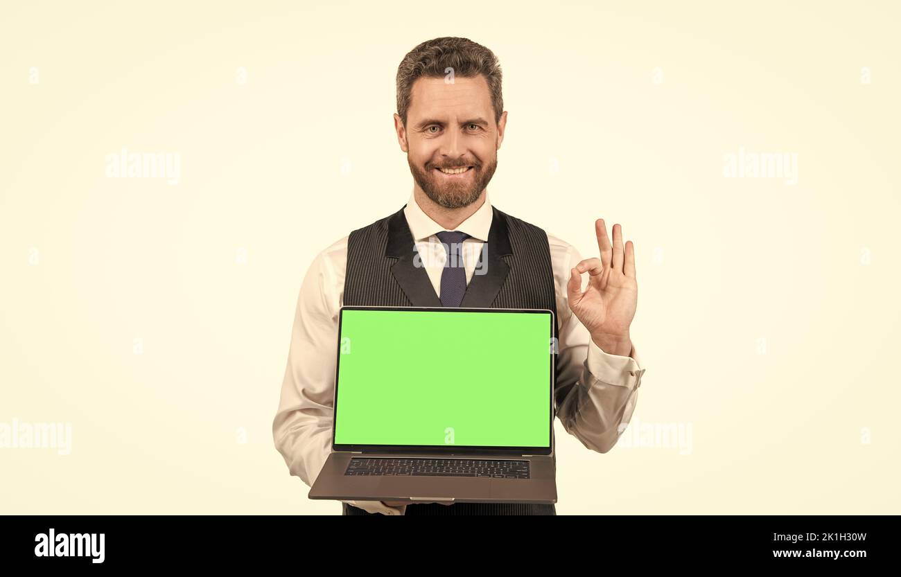 happy man presenting product of pc with green screen for copy space ...