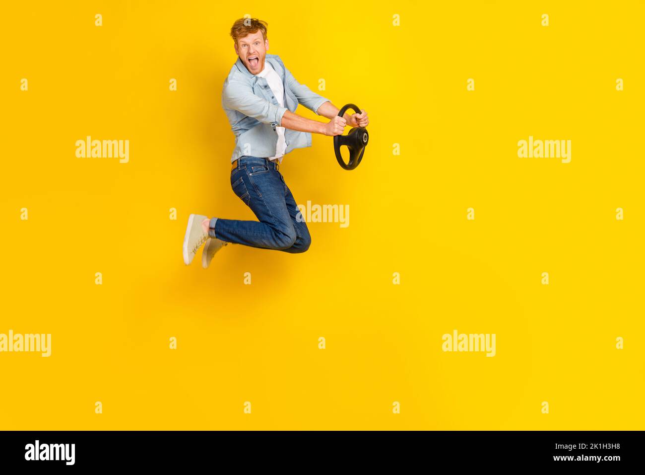 Full length photo of careless handsome guy blue shirt jeans sneakers ...
