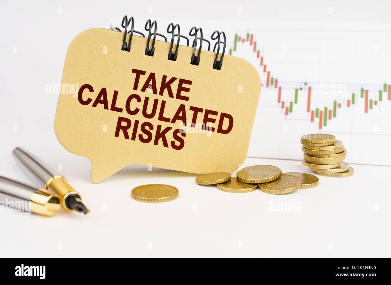 Business concept. On the table are coins, a pen, a graph and a sign ...