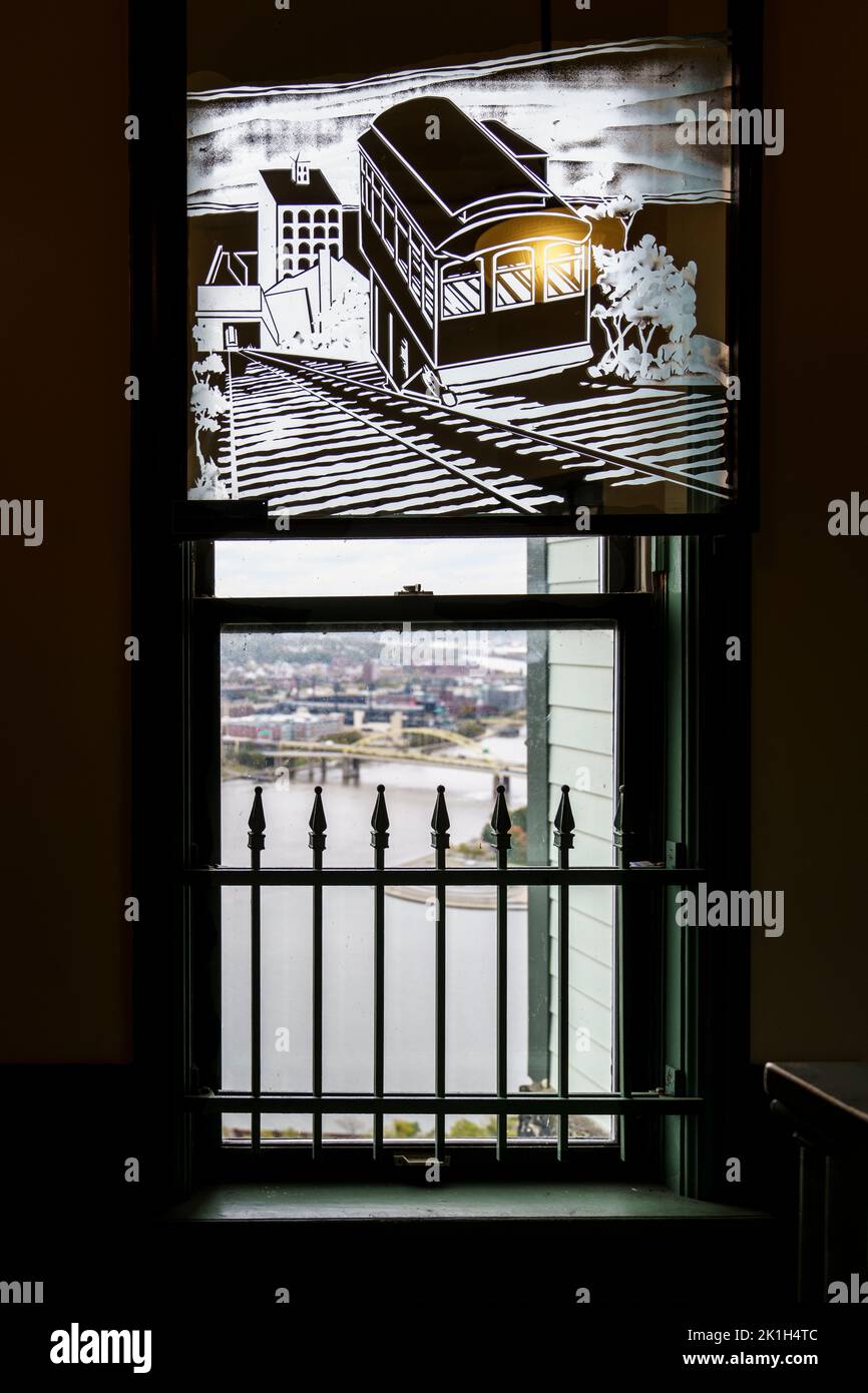 Etched glass picture of a cable car is shilouetted above a window in ...