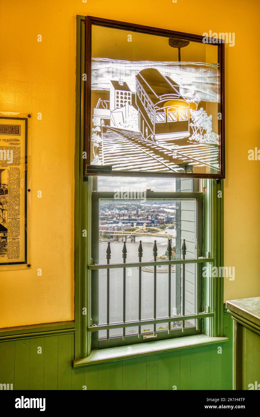An etched glass picture of a cable car sits above a window in the Upper ...