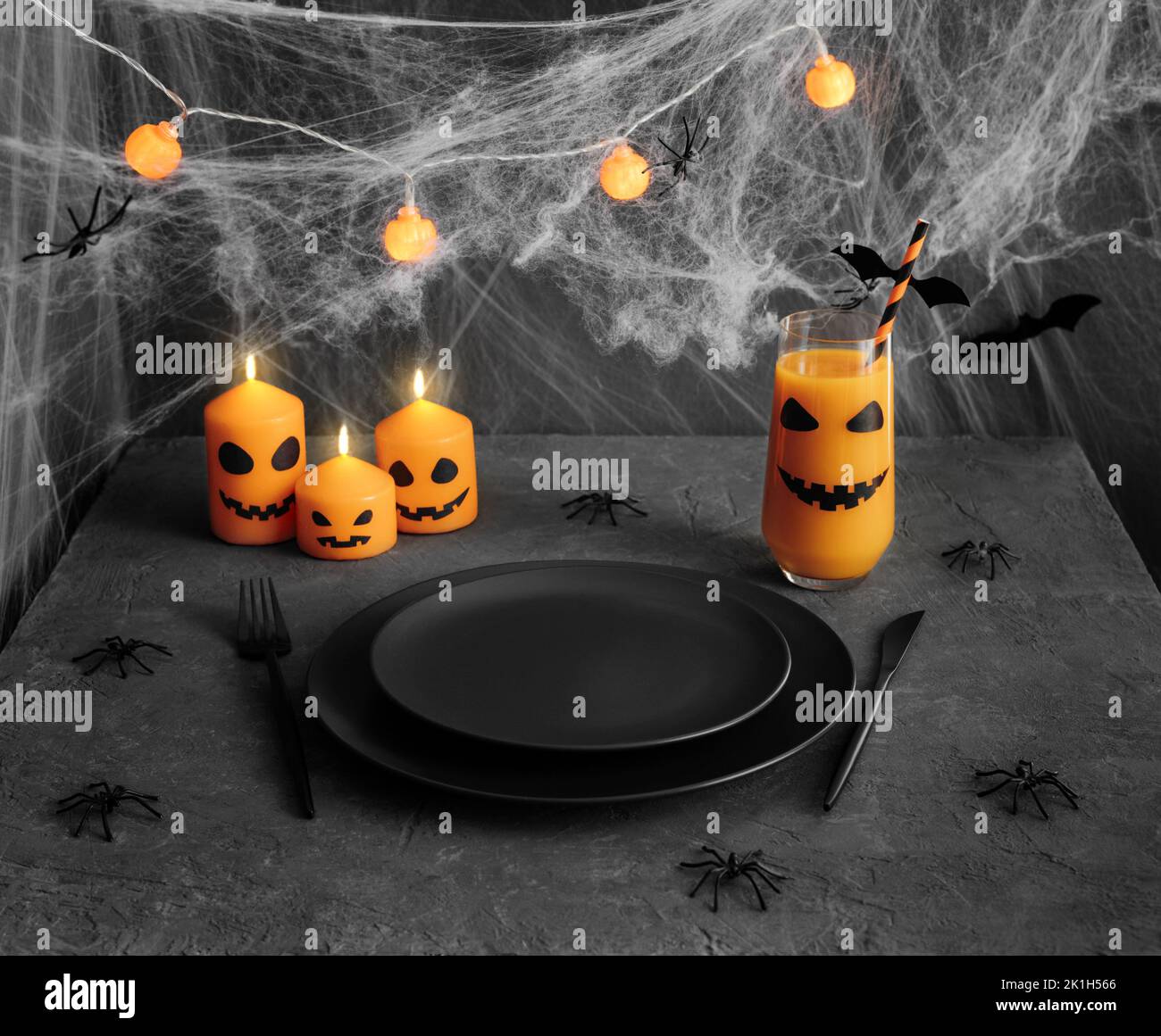 Halloween table setting with black cutlery. Festive serving with ...