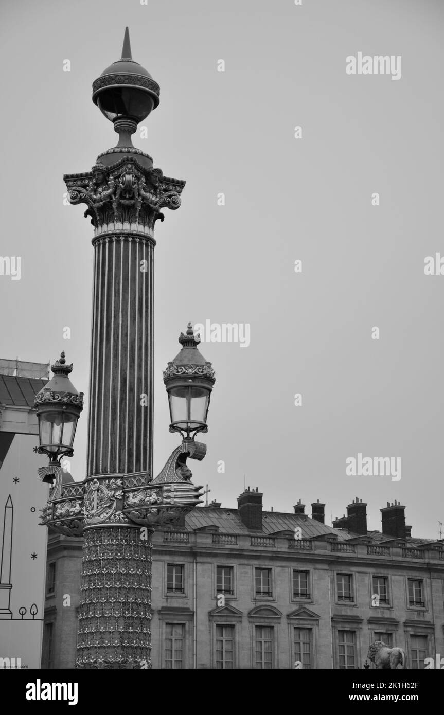 A grayscale of a Historic street light with gold and gas lamps in Paris ...