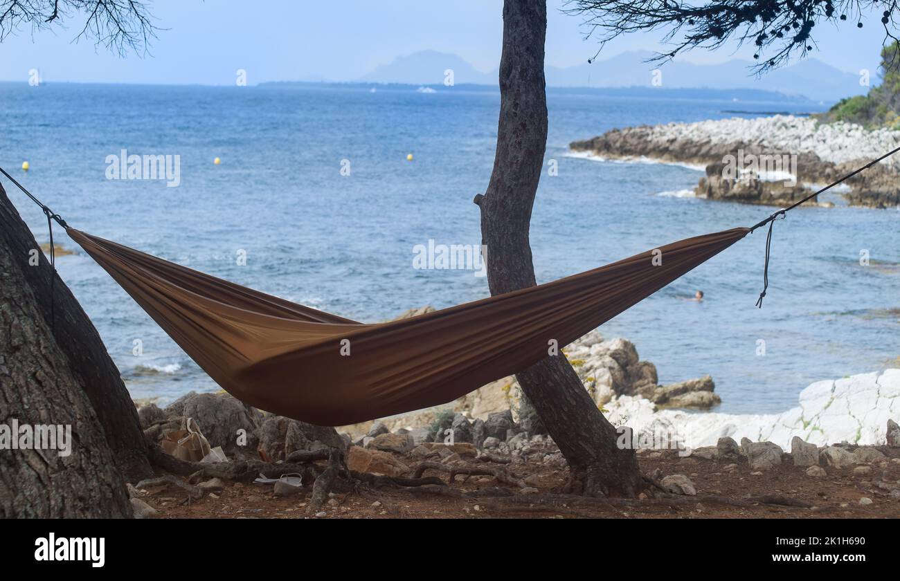 Hammock stretched between two trees in front of the sea at Cap d ...