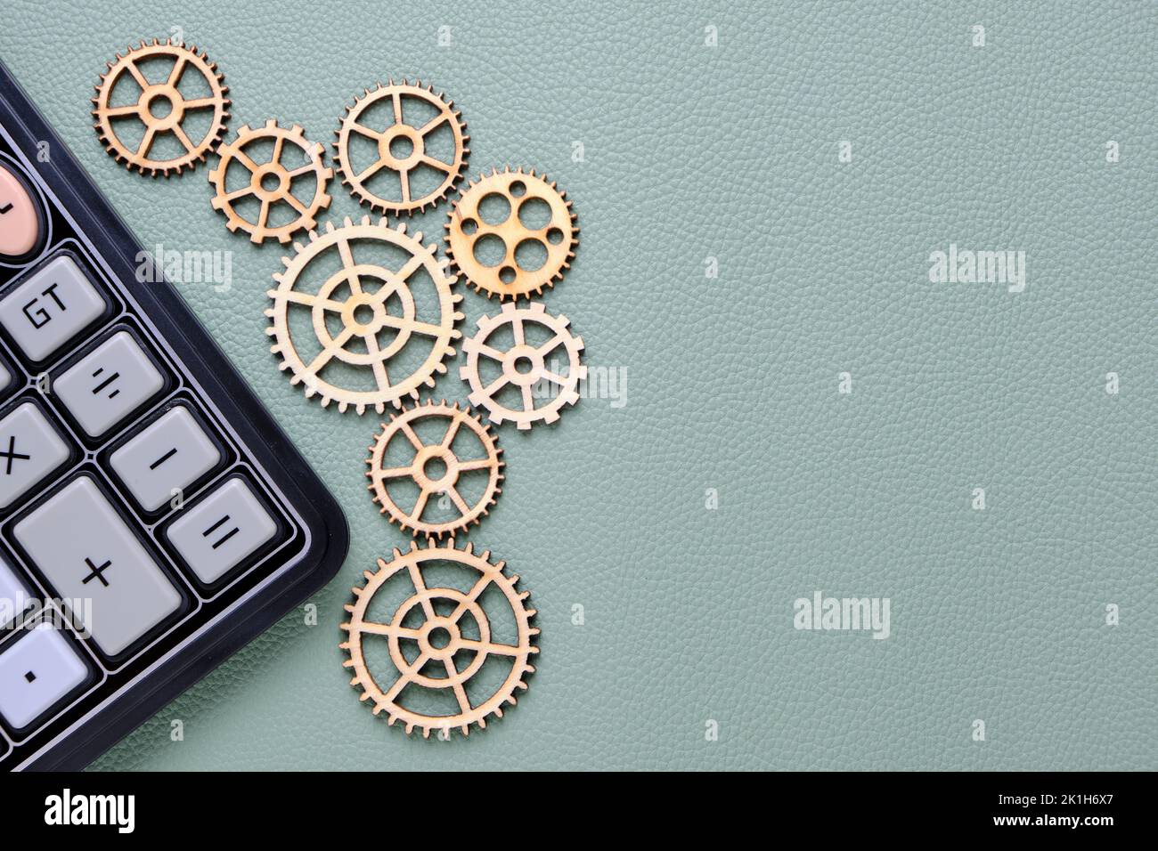 Calculator and gears on table with skin texture background Stock Photo ...