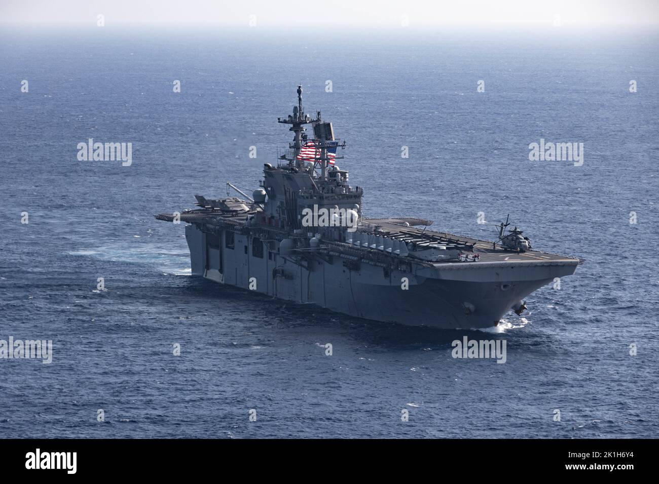 Amphibious assault carrier USS Tripoli (LHA 7) sails in the Philippine Sea during a photo ...