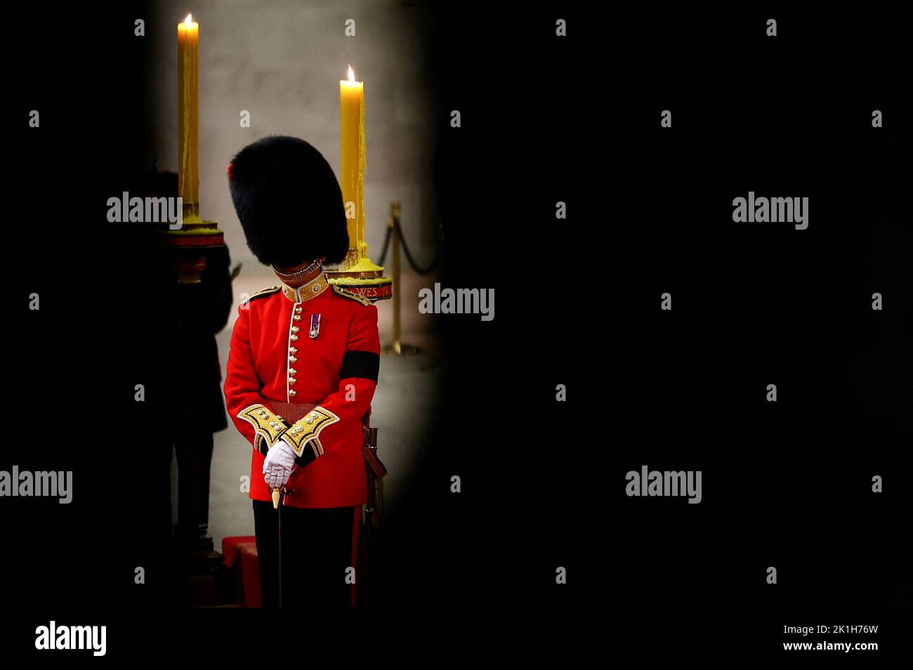 A royal guard stands beside the coffin of Queen Elizabeth II, draped in ...