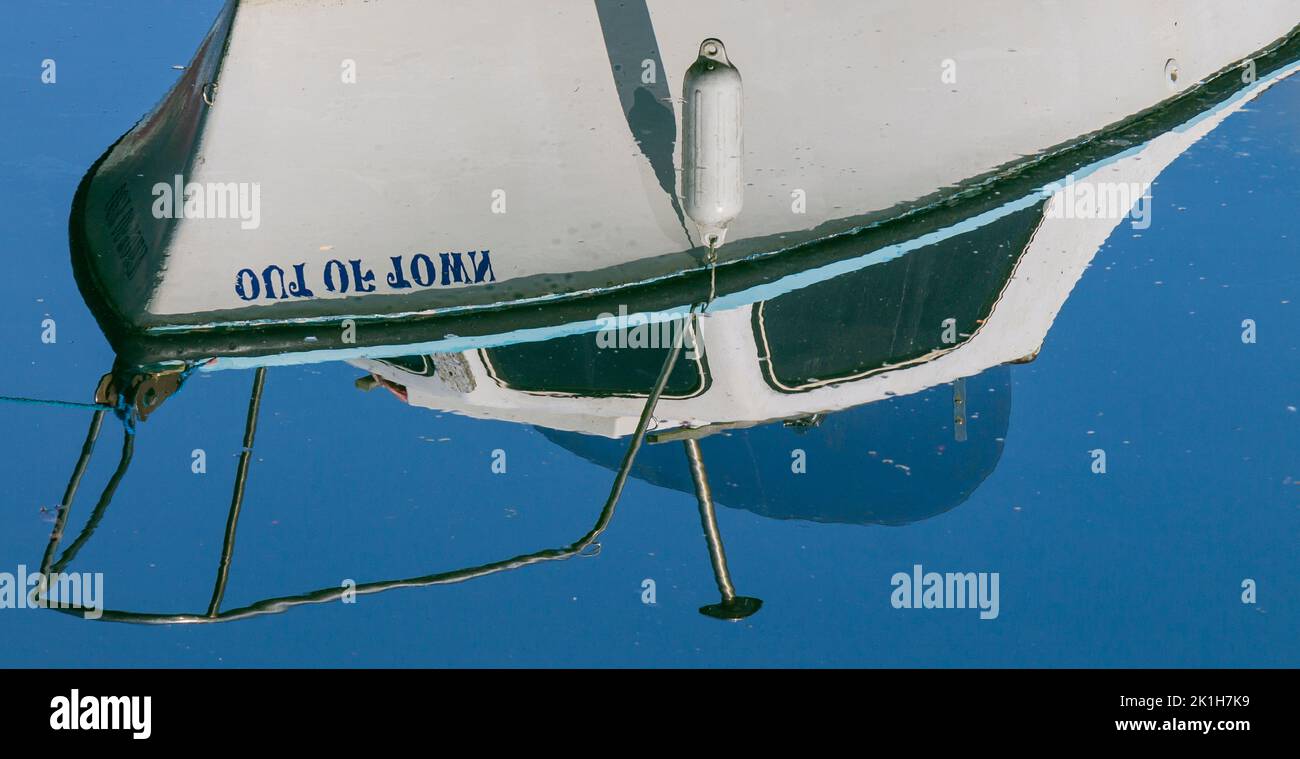 Boat reflections in flat calm water Stock Photo - Alamy