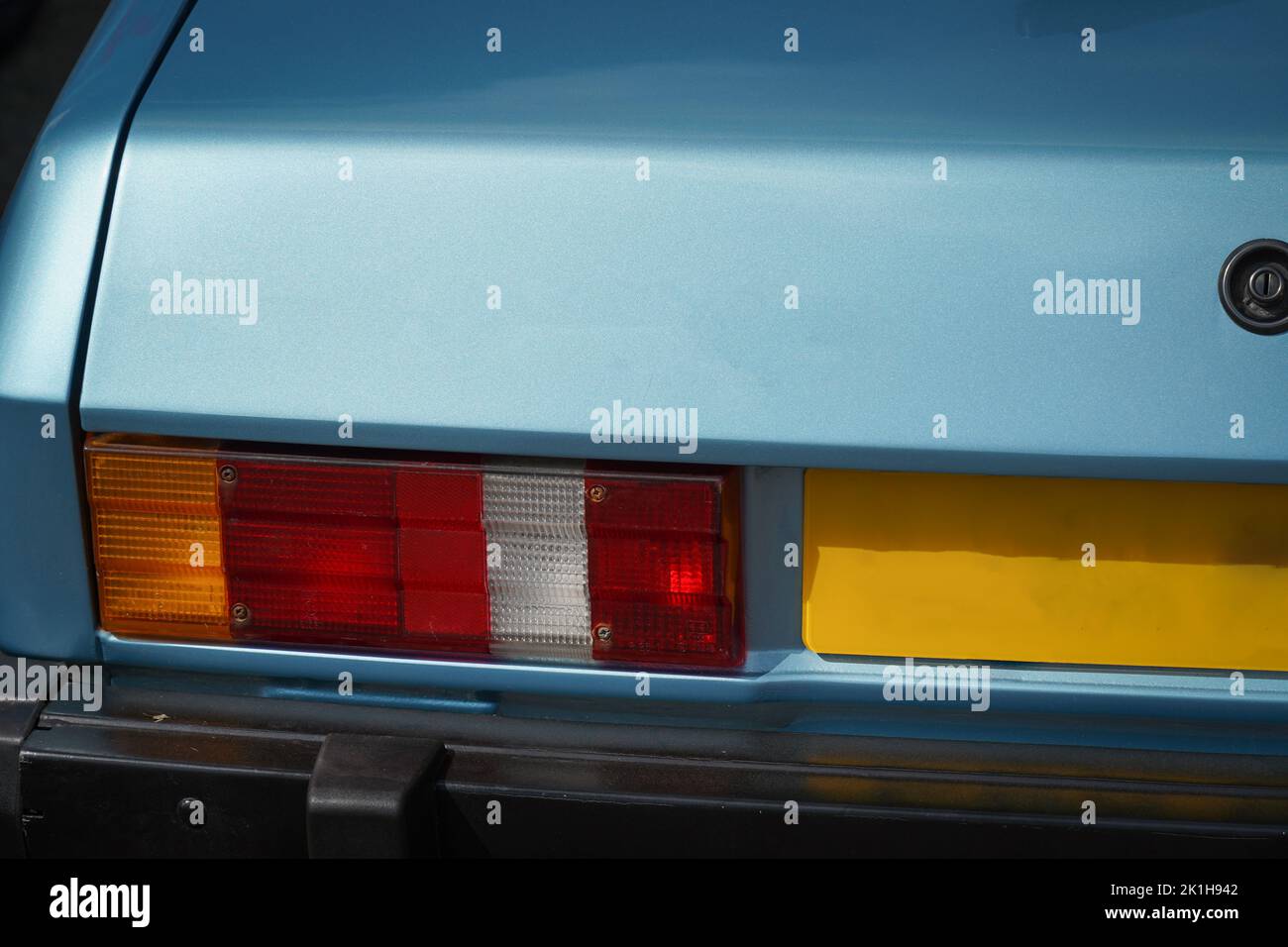 Close up of the rear light (taillight) of a classic blue car from 1980s ...