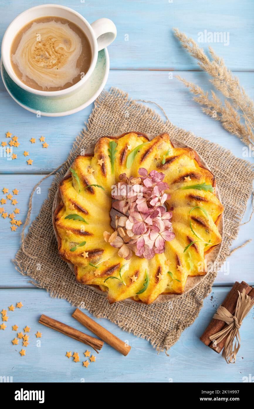 Cheesecake with cup of coffee on blue wooden background and linen ...