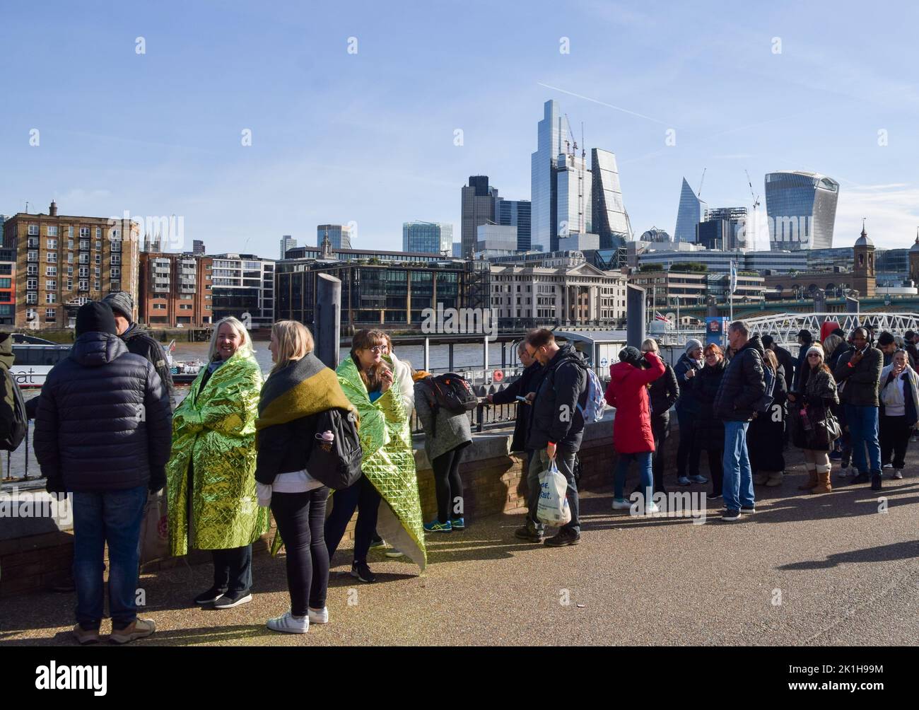 London, UK. 18th Sep, 2022. Mourners try to stay warm in the early ...