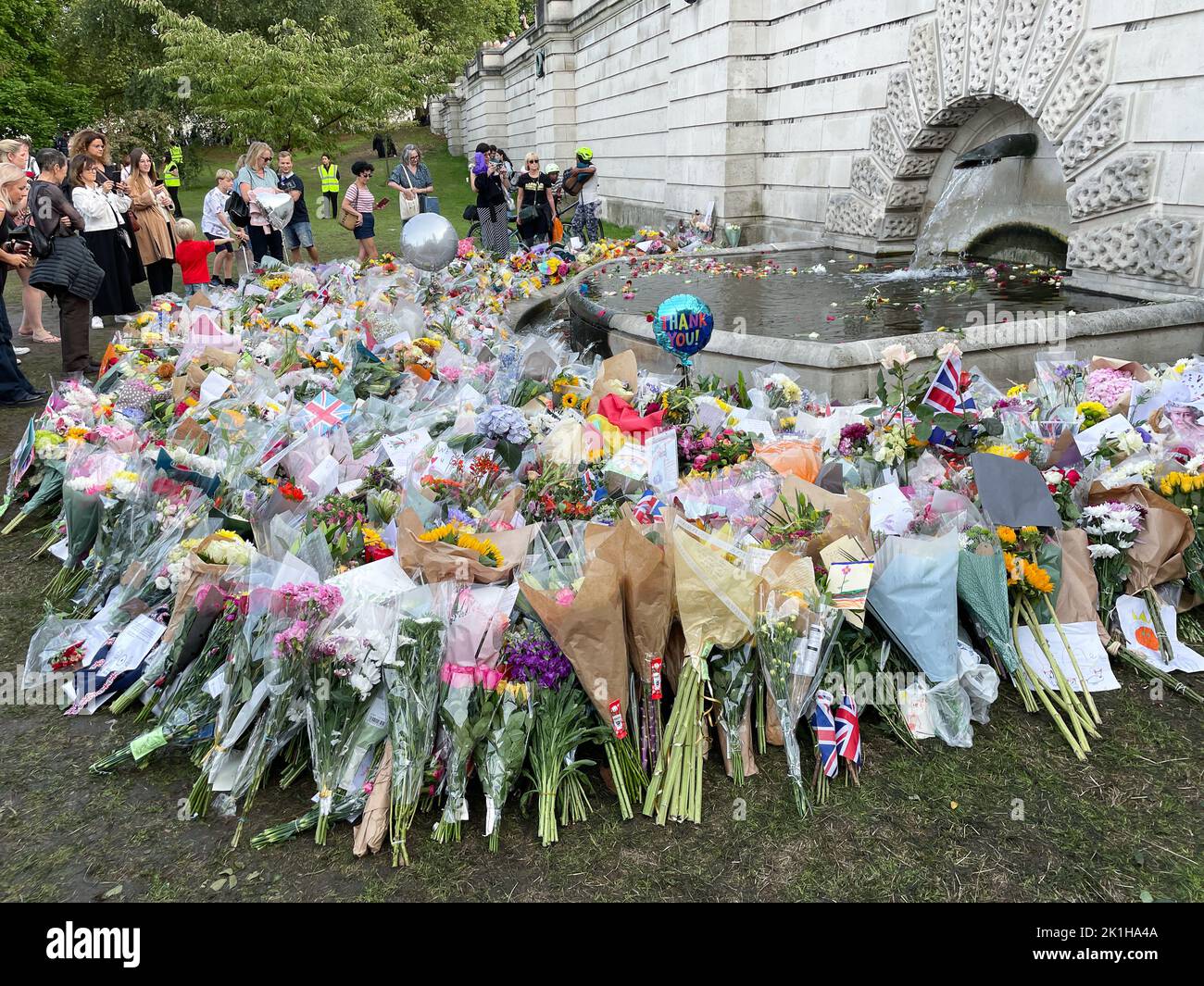 London, UK - September 11 2022: Flowers being laid outside Buckingham Palace on the announcement ...