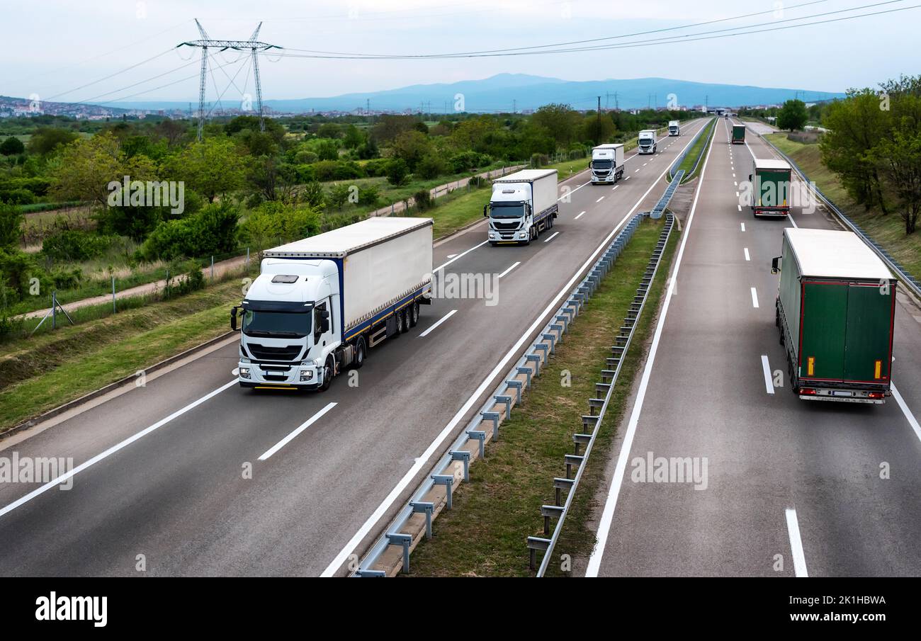 White trucks on highway - heavy truck traffic on the highway in the ...