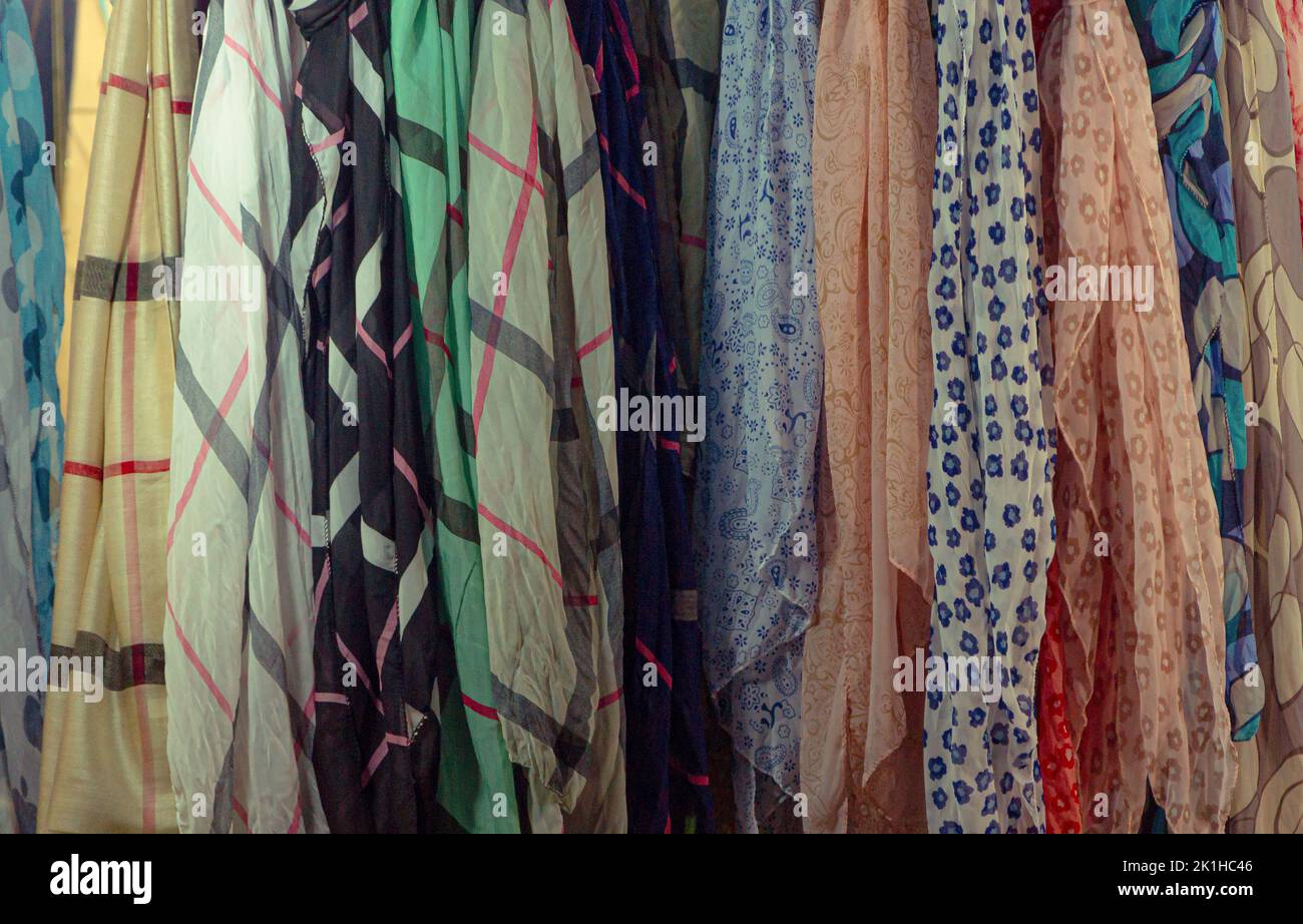 Colored scarves tied on the hanging bar Stock Photo - Alamy