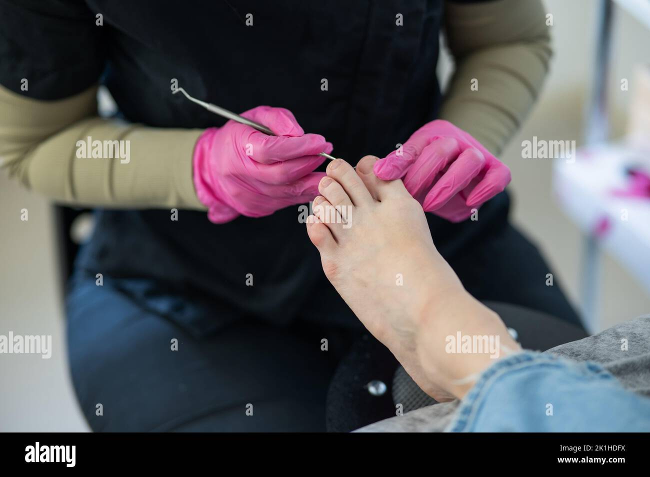 Podiatrist makes a pedicure to a client. The master conducts hygiene of ...