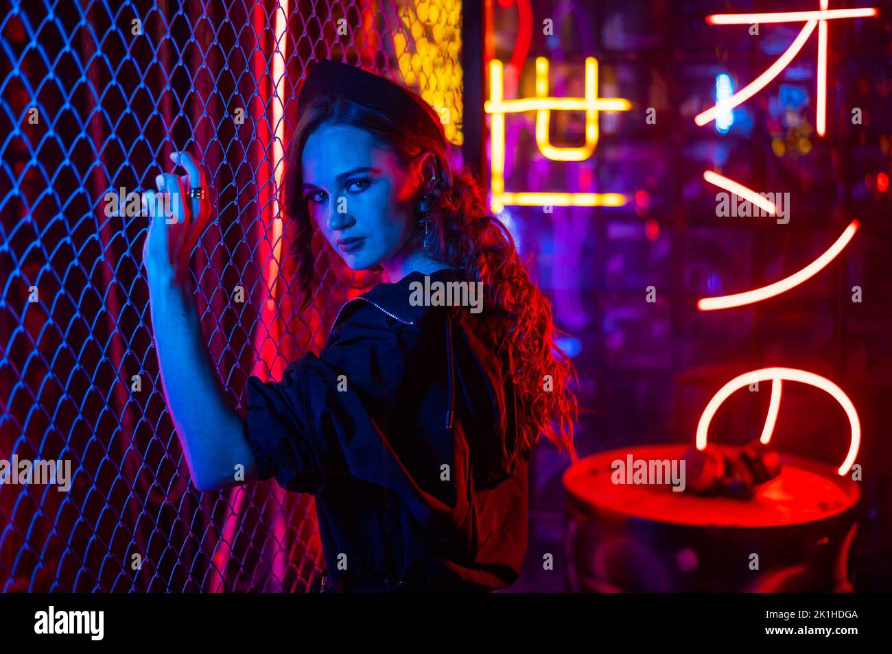 Caucasian woman posing in neon studio Stock Photo - Alamy