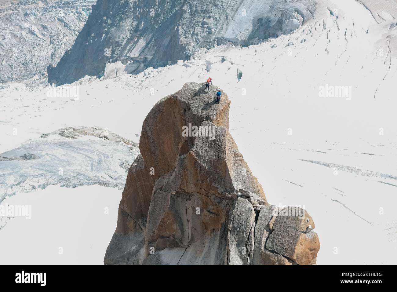 Climbers traverse mountain ridges and rocks near Montblanc Stock Photo ...