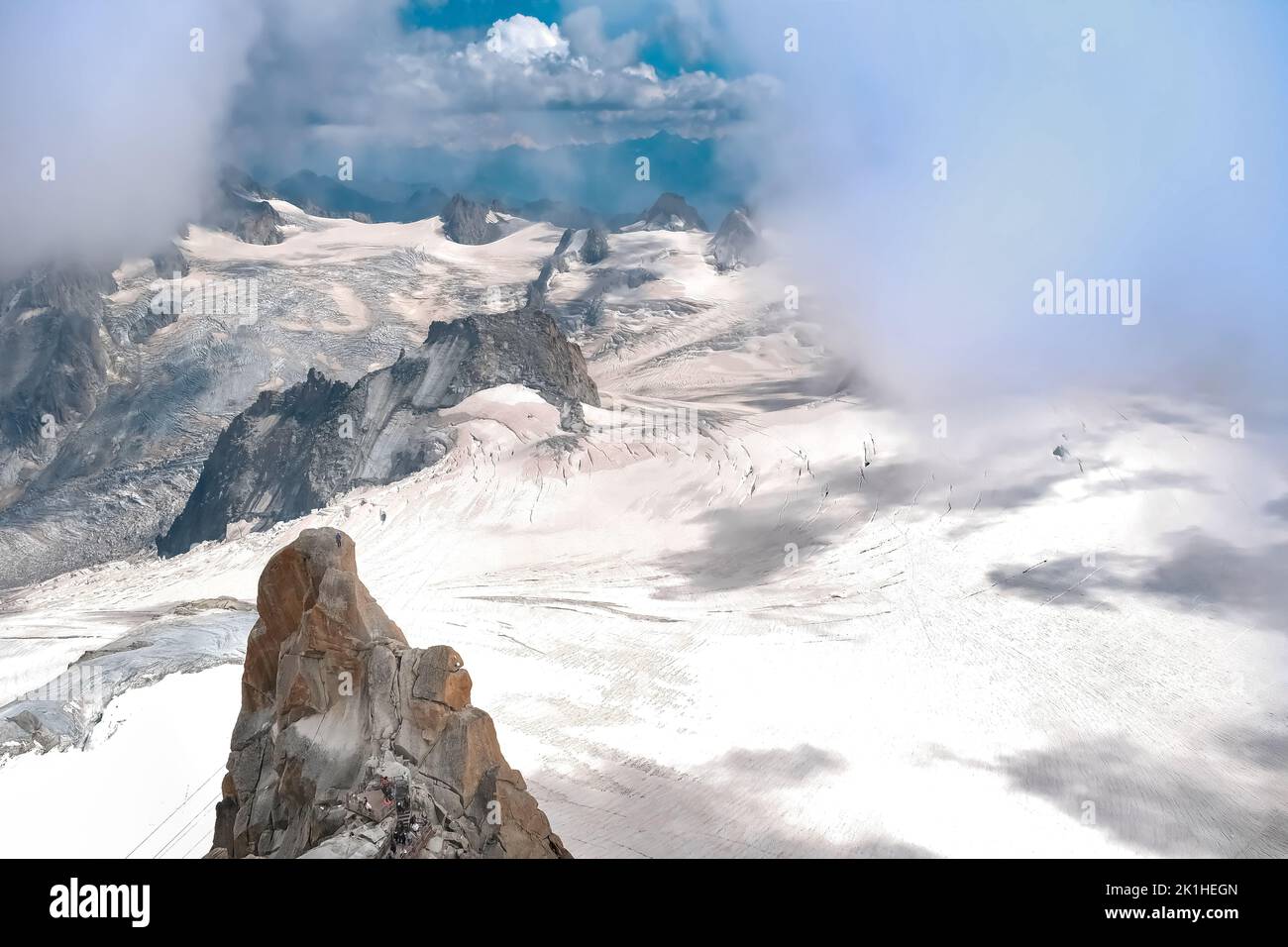 Climbers traverse mountain ridges and rocks near Montblanc Stock Photo ...
