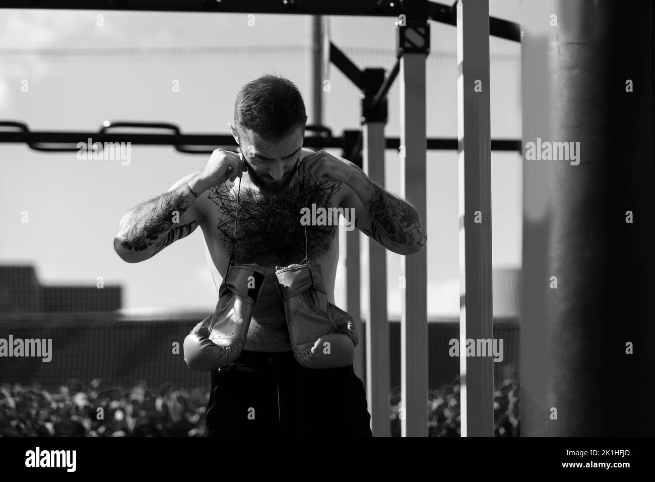 a man trains in boxing gloves on the street Stock Photo - Alamy
