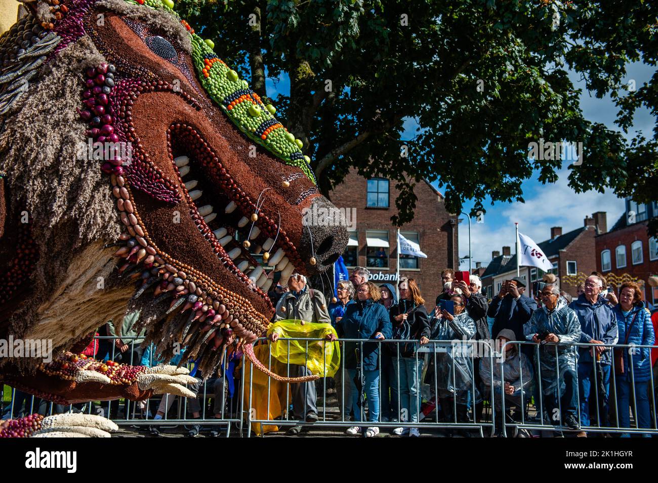 People are seen taking photos and admiring one of the fruit floats with ...