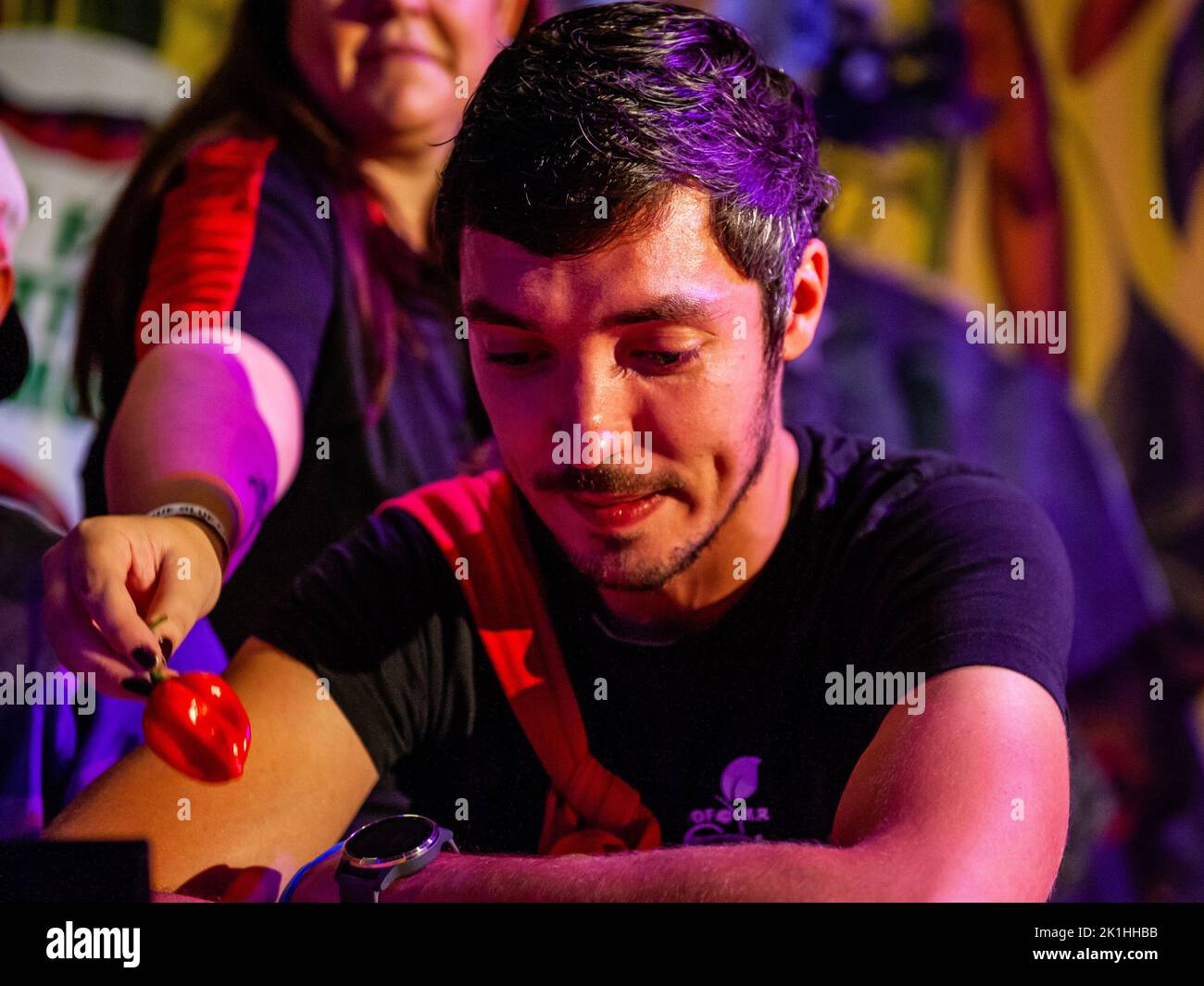 A participant looks with concern at the next chili to eat during the ...