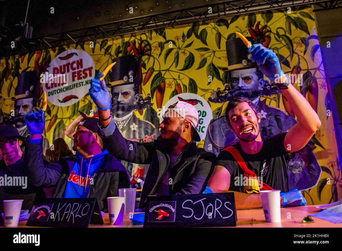 Participants are seen showing the audience the peppers before eating ...