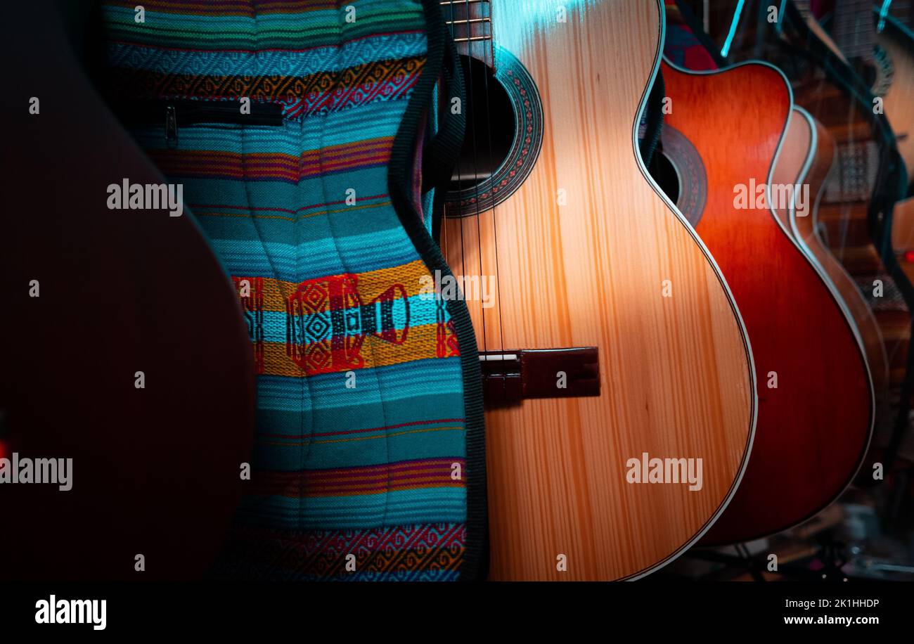 A row of various multi-colored acoustic guitars in a store Stock Photo ...