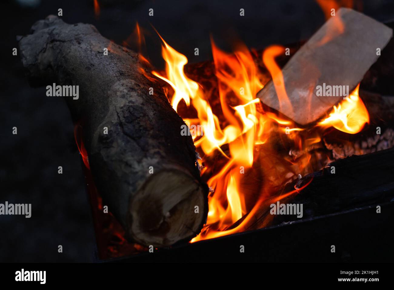 Defocus fire flame firewood fireplace wood. Bright flames burning wood ...