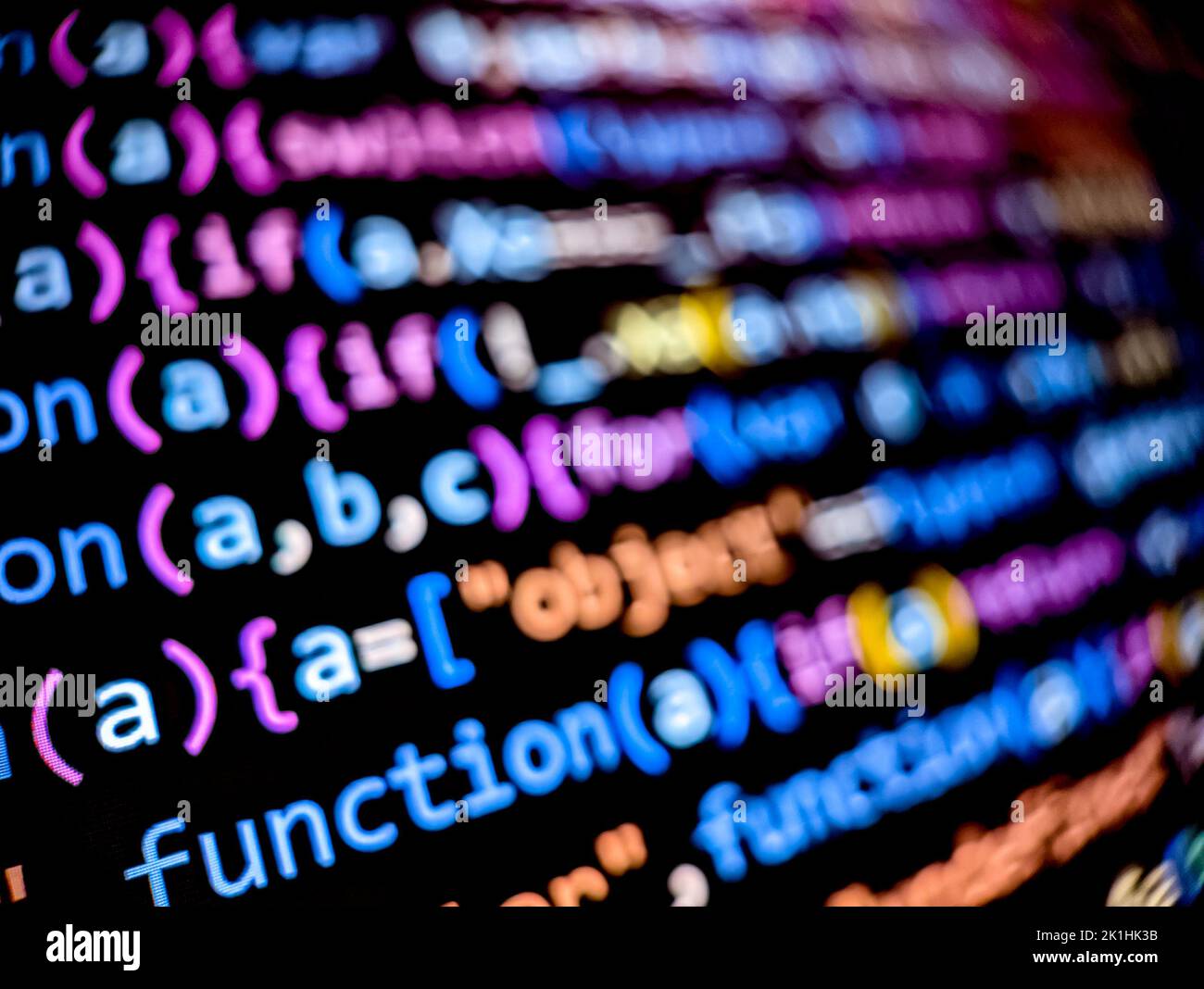 Closeup view of software code on a computer screen with blurred ...