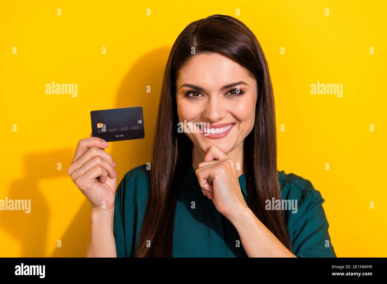 Photo of young cheerful woman hand touch chin credit card benefit ...