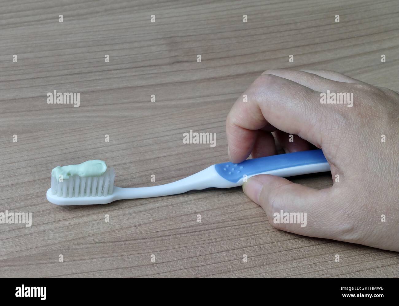 Hand Holding Toothbrushes with Toothpaste. An Oral Hygiene Instrument ...
