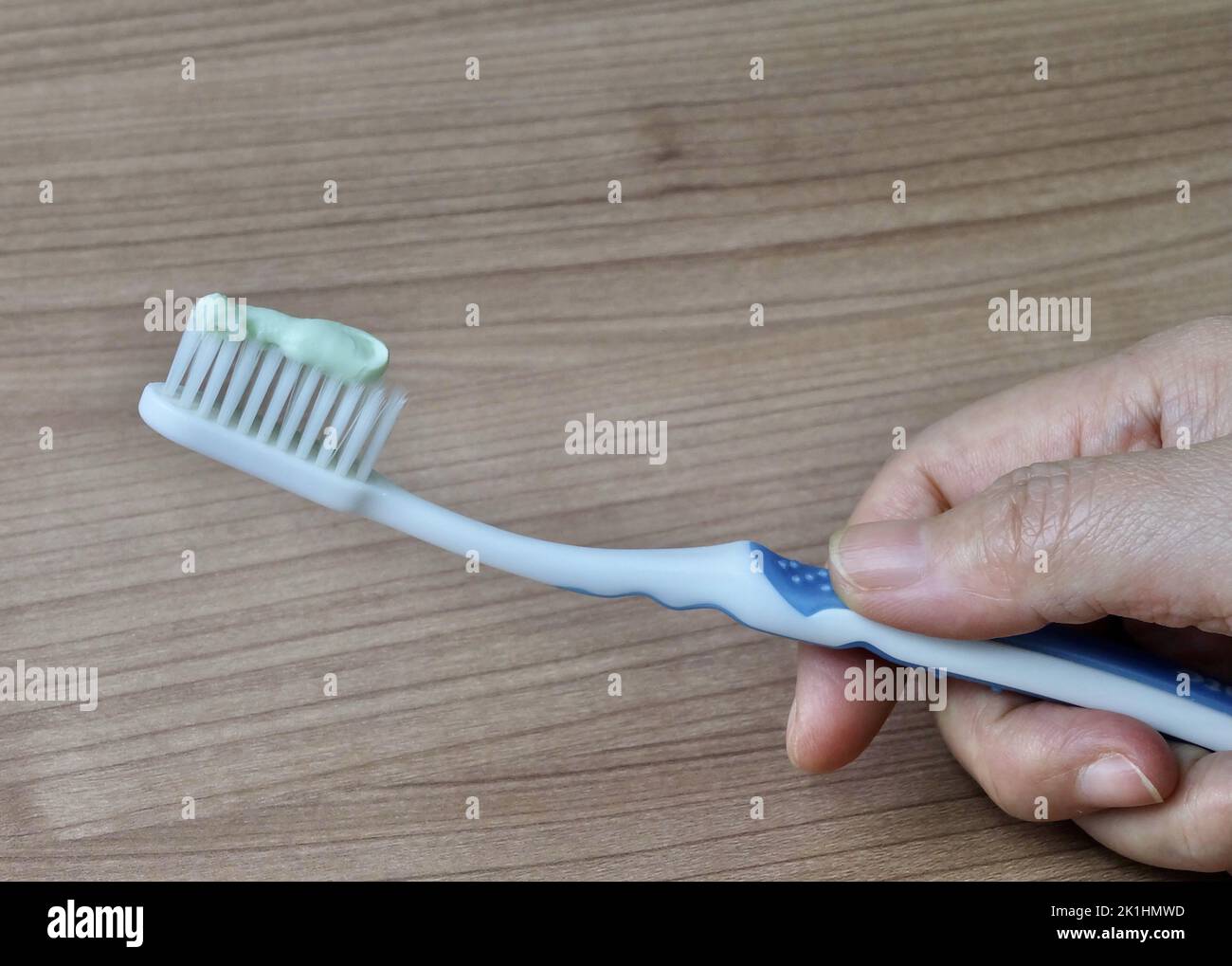Hand Holding Toothbrushes with Toothpaste. An Oral Hygiene Instrument ...