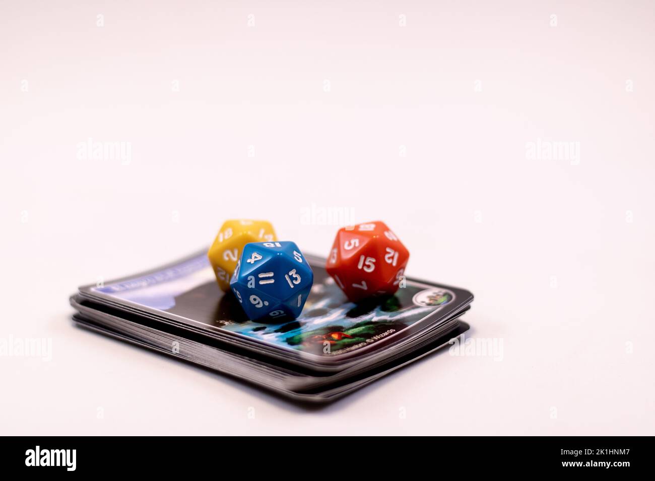 yellow, blue, red role play game dice over cards Stock Photo - Alamy