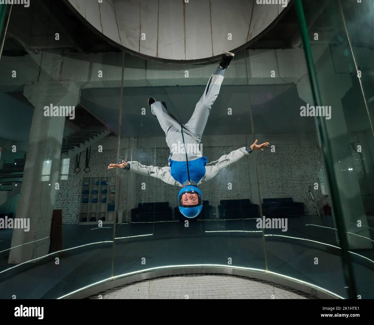 A woman flies in a wind tunnel. Free fall simulator Stock Photo - Alamy