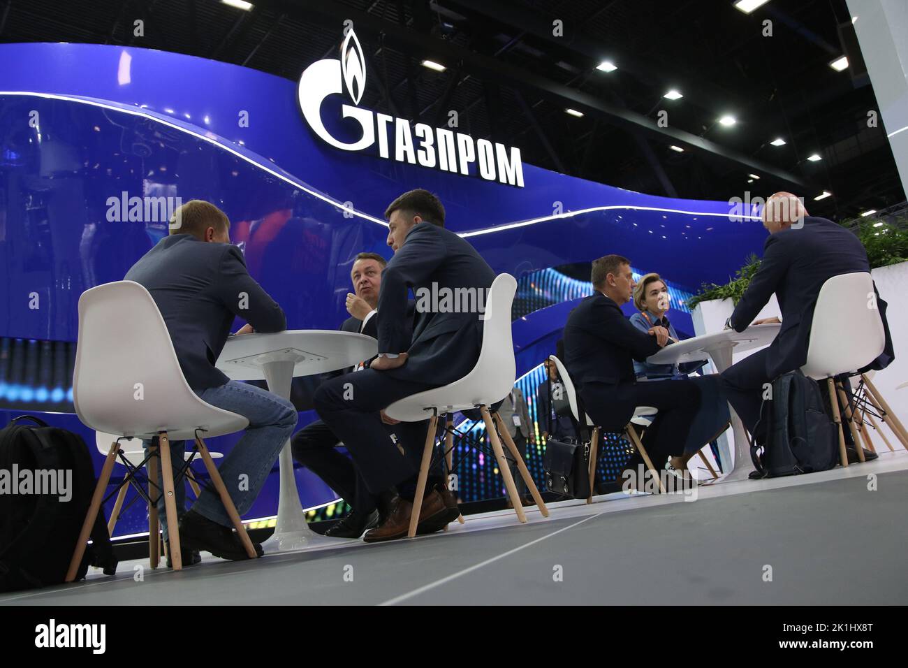Gazprom employees and staff in a cafe on the background of the Gazprom ...