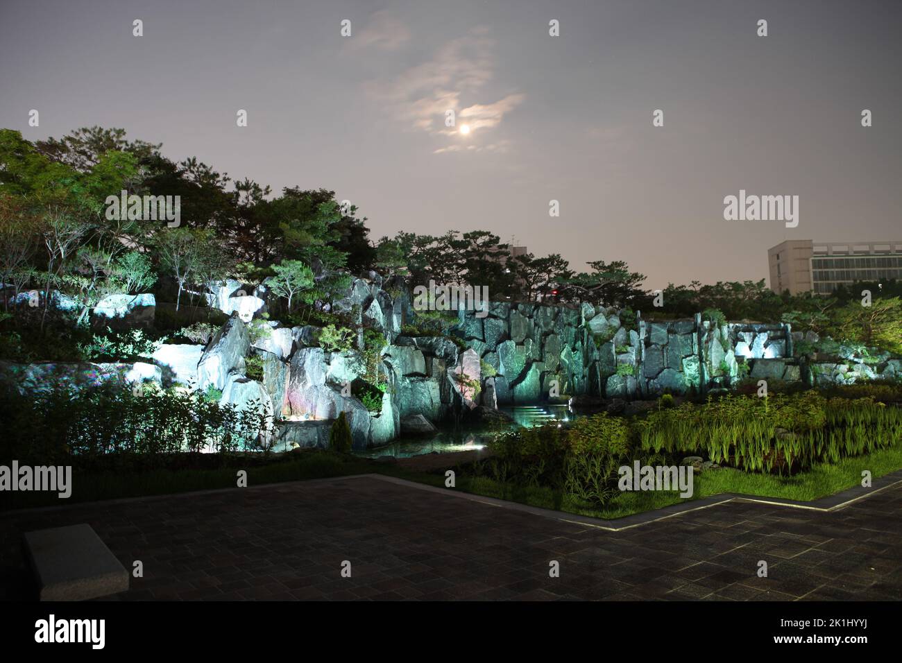 The moon is rising over the stone wall, where the lighting changes from ...