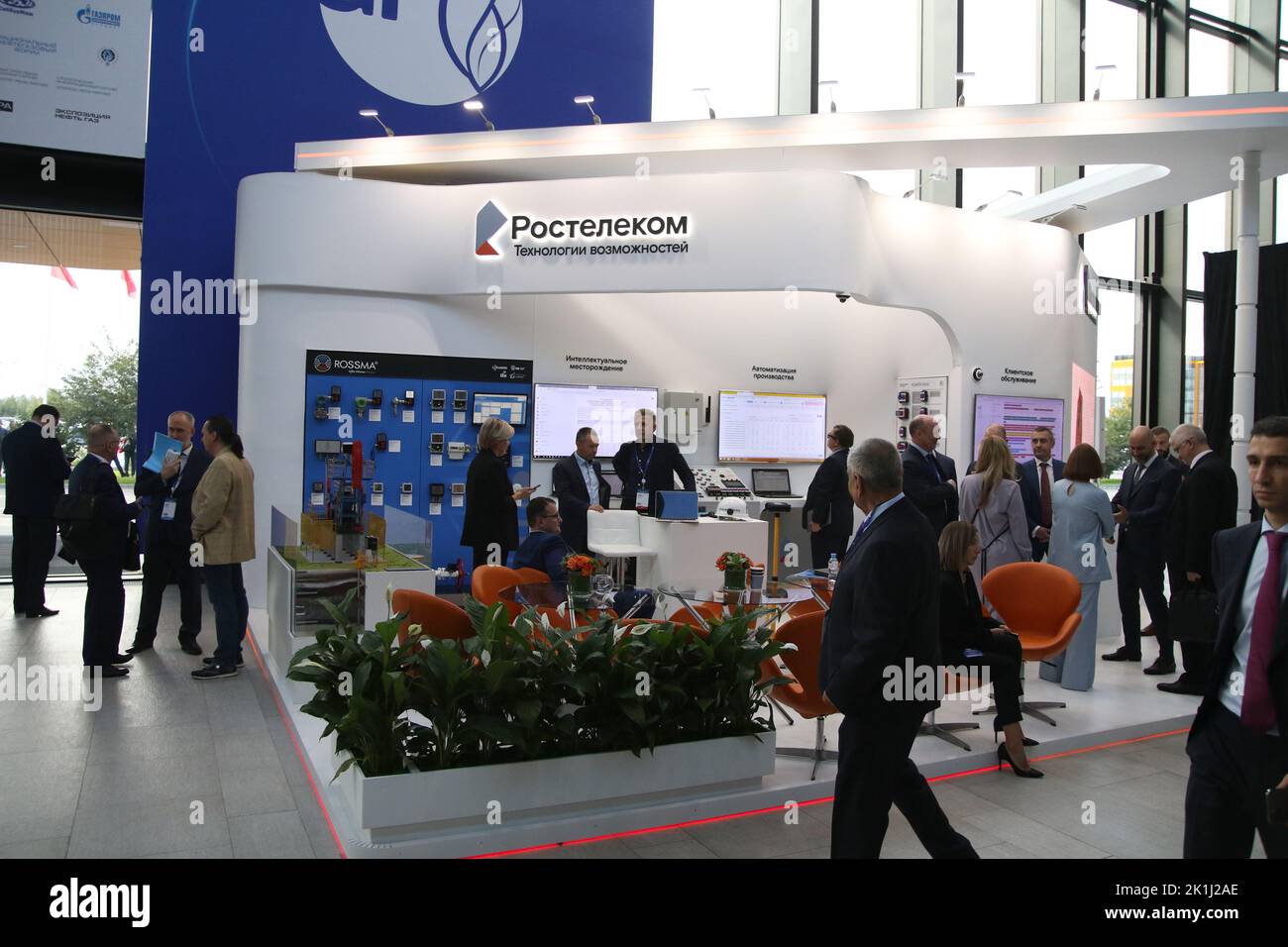 Visitors near logo Rostelecom on the St. Petersburg International Gas ...