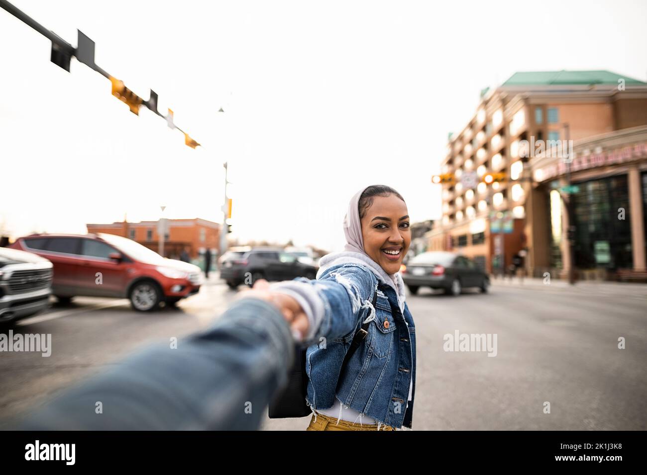 Personal perspective young woman holding hands with boyfriend on city ...