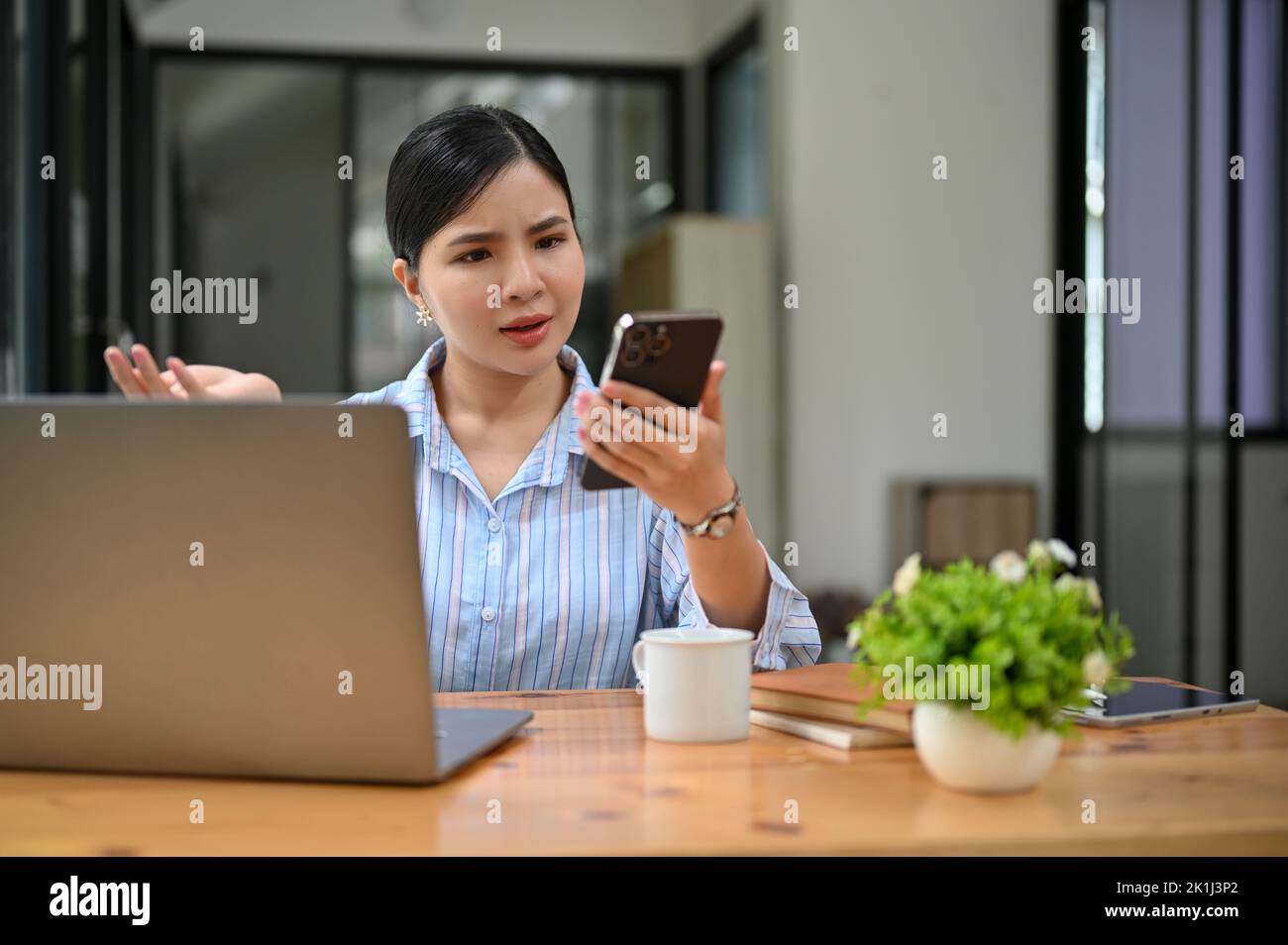 Annoyed millennial Asian businesswoman or female office employee having ...