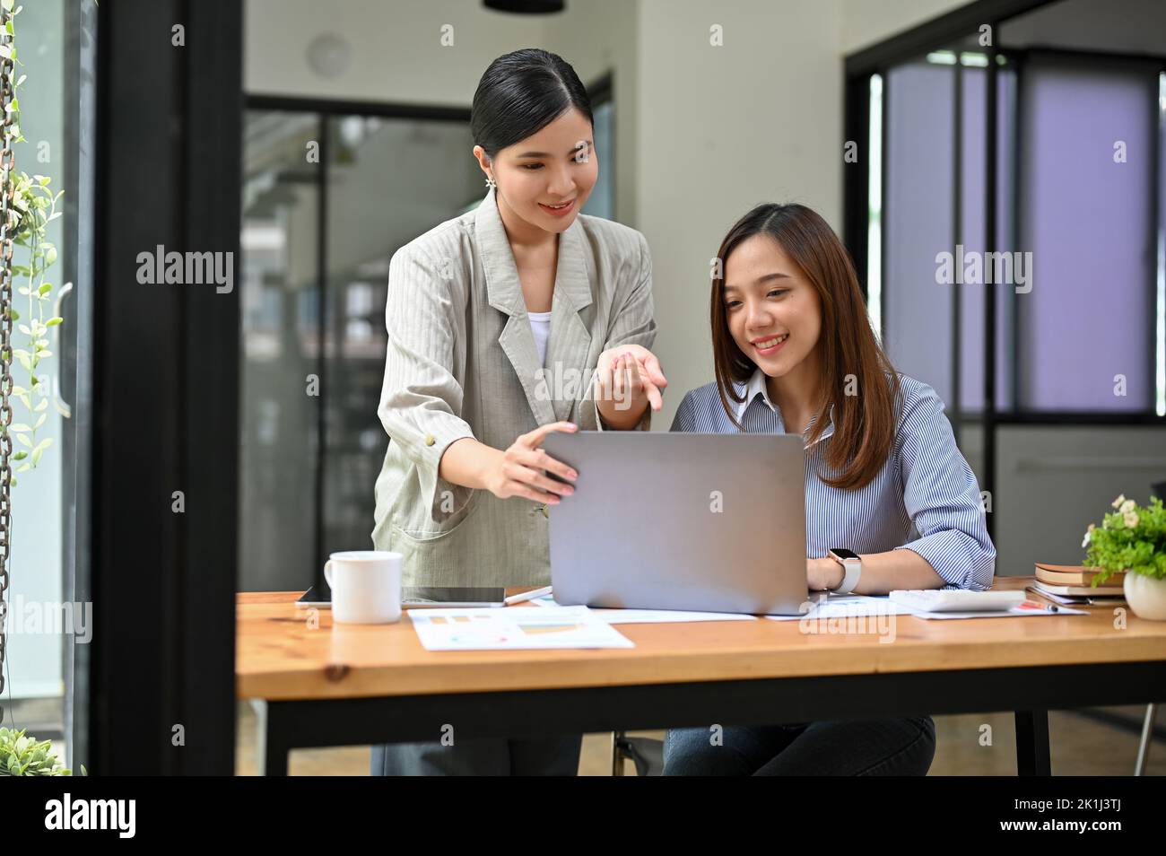 Professional millennial Asian female boss is training and giving some ...