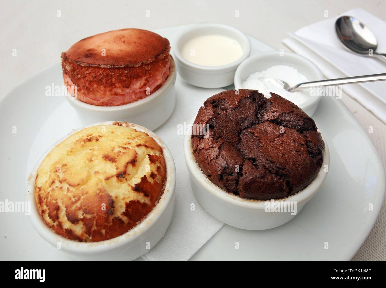 Chocolate, strawberry and coconut souffles on the dessert plate Stock ...