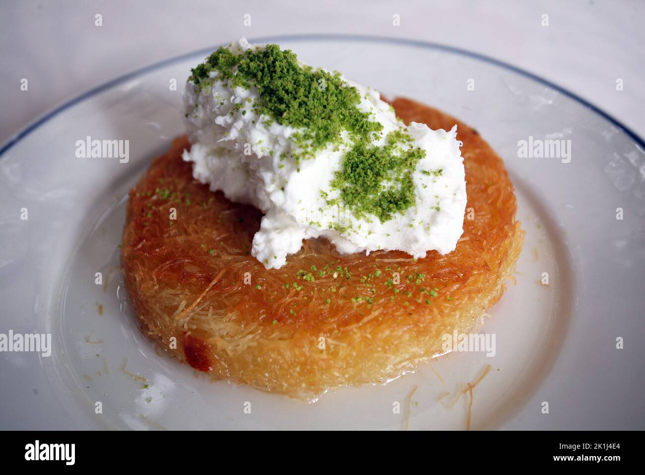Traditional Turkish dessert 'Kunefe' on the dessert plate Stock Photo ...