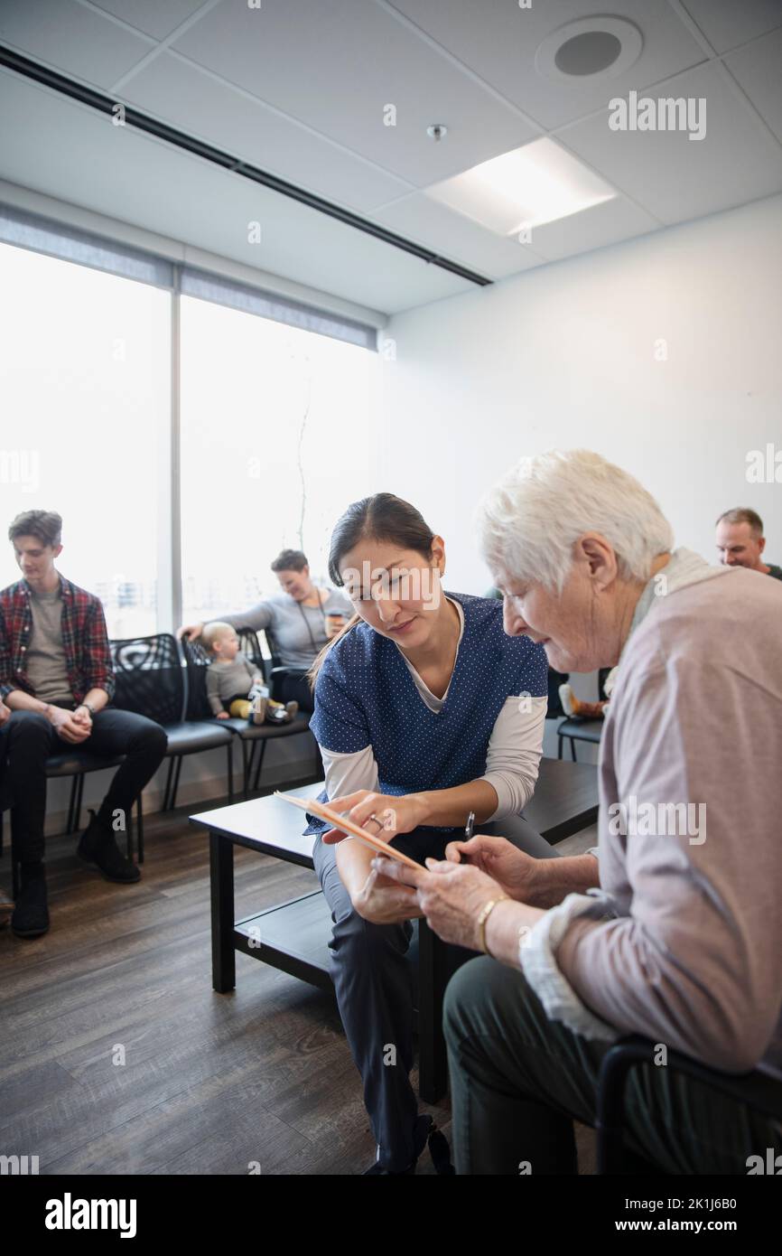 Doctor giving patient documents hi-res stock photography and images - Alamy