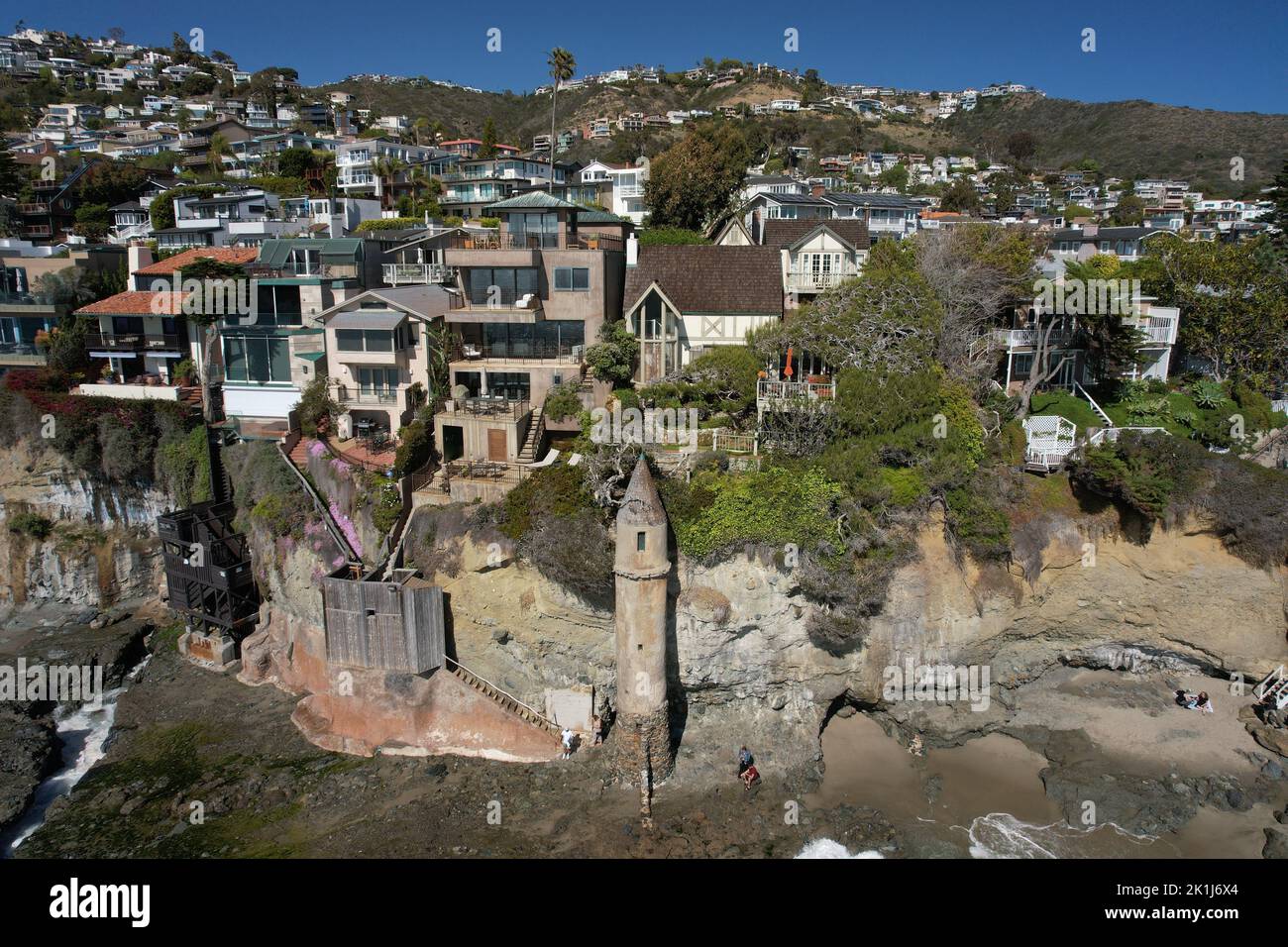 An aerial view of residential houses built on a cliff near the beach in ...