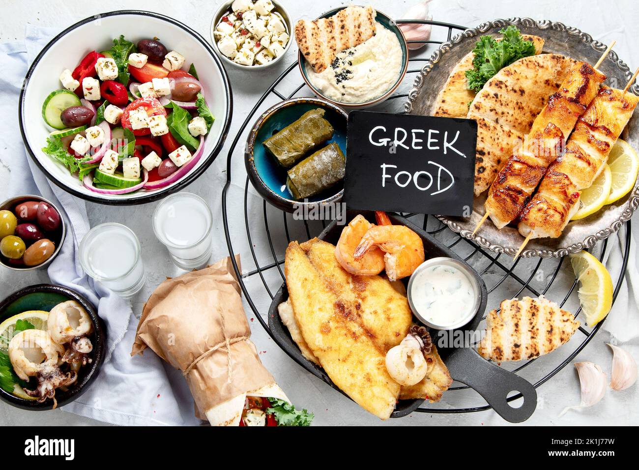 Greek food background. Meze, gyros, souvlaki, fish, pita, greek salad ...