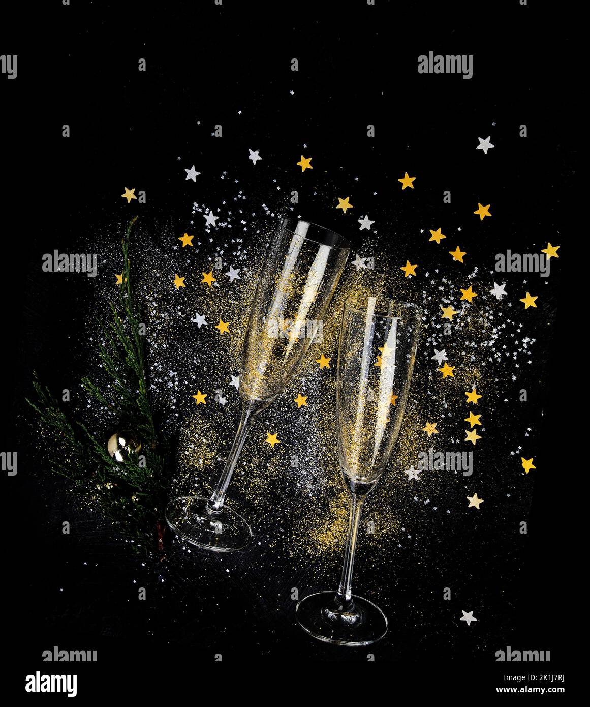 Two champagne glasses. Christmas decoration on a black background ...
