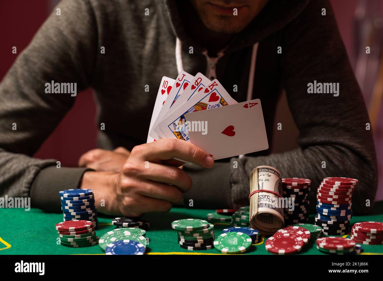 Happy poker player winning and holding cards Stock Photo - Alamy