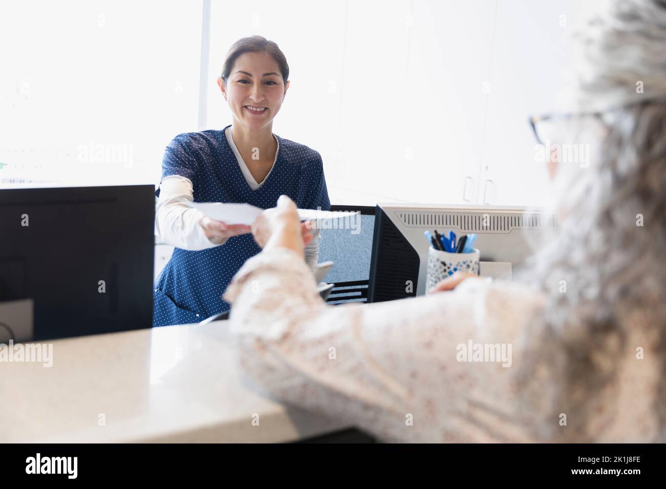Doctor giving patient documents hi-res stock photography and images - Alamy